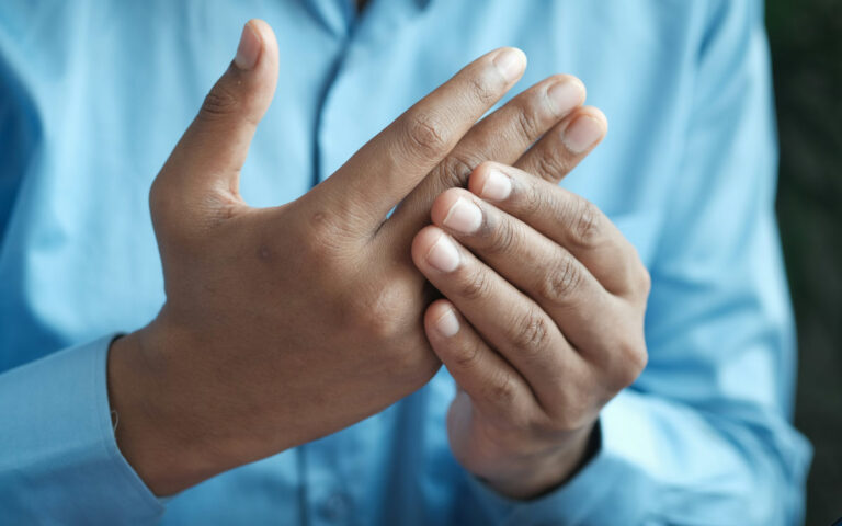 Why do my hands go numb when I'm using my phone and how can I avoid it?