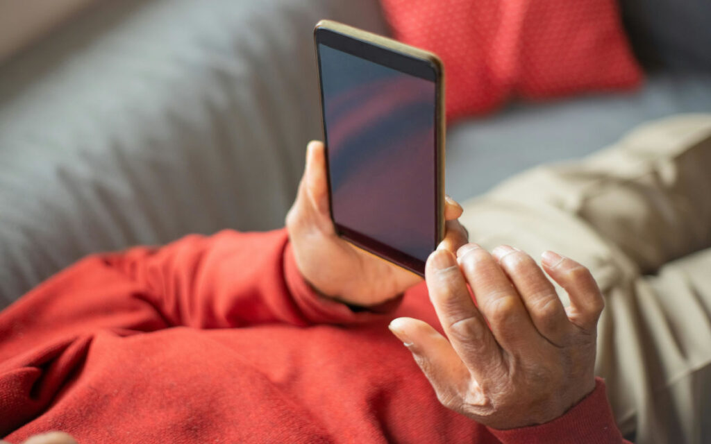 Why do my hands go numb when I'm using my phone and how can I avoid it?